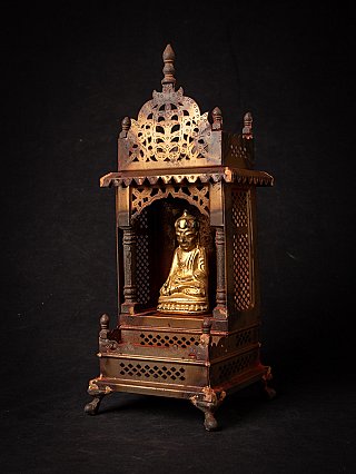Old metal temple with antique wooden Buddha statue from Nepal
