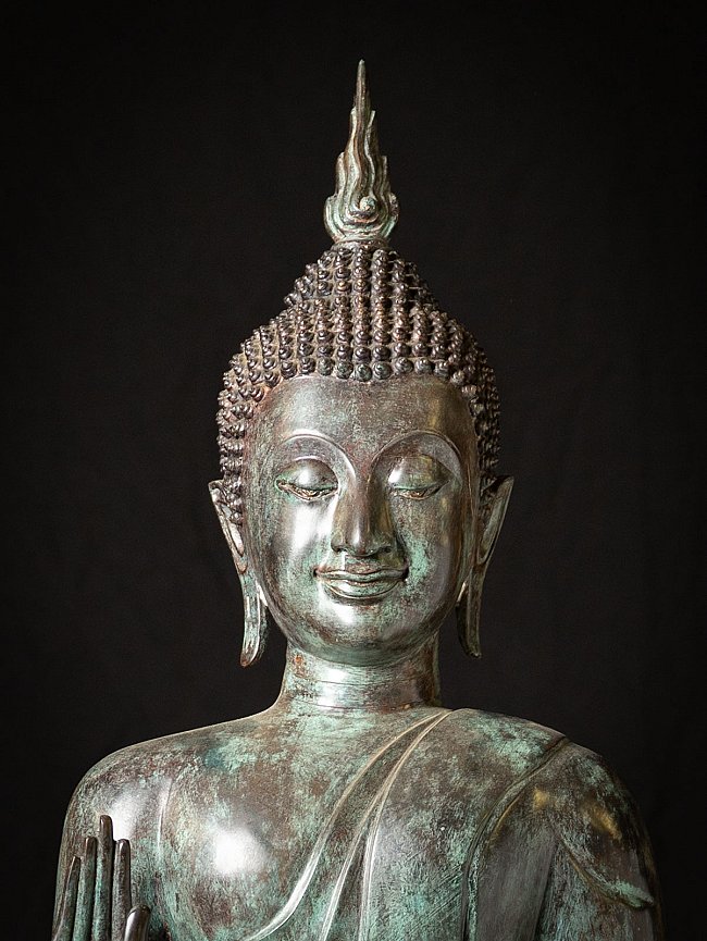 Old standing bronze Thai Buddha statue from Thailand